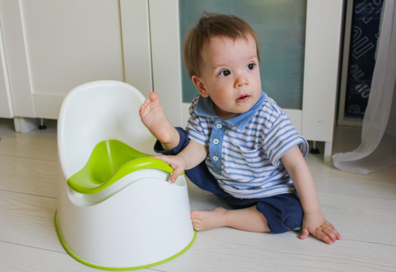 A little boy learns to go potty. Accustom the child to the potty ...